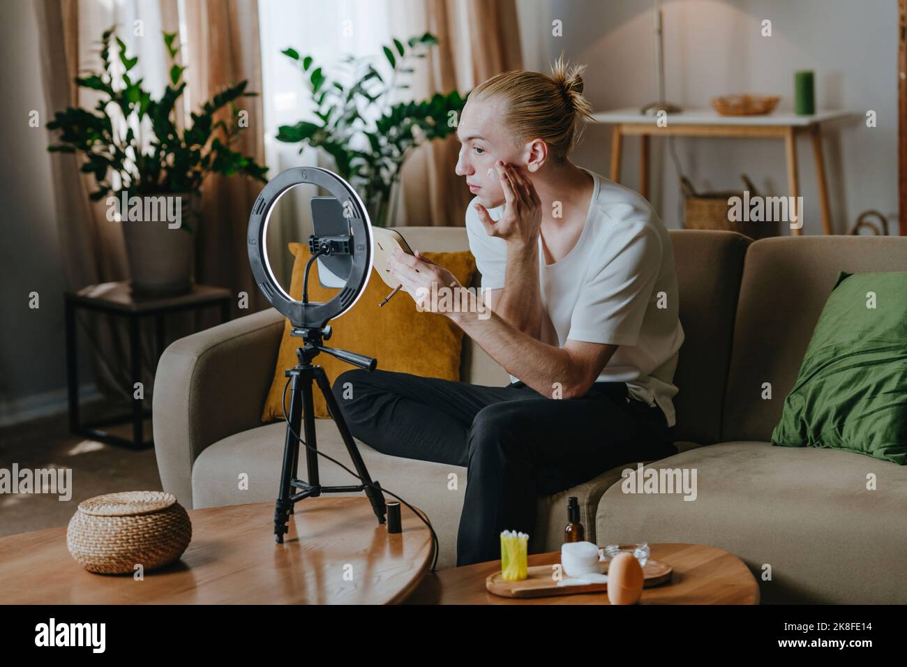 Applying makeup with phone hi-res stock photography and images - Alamy