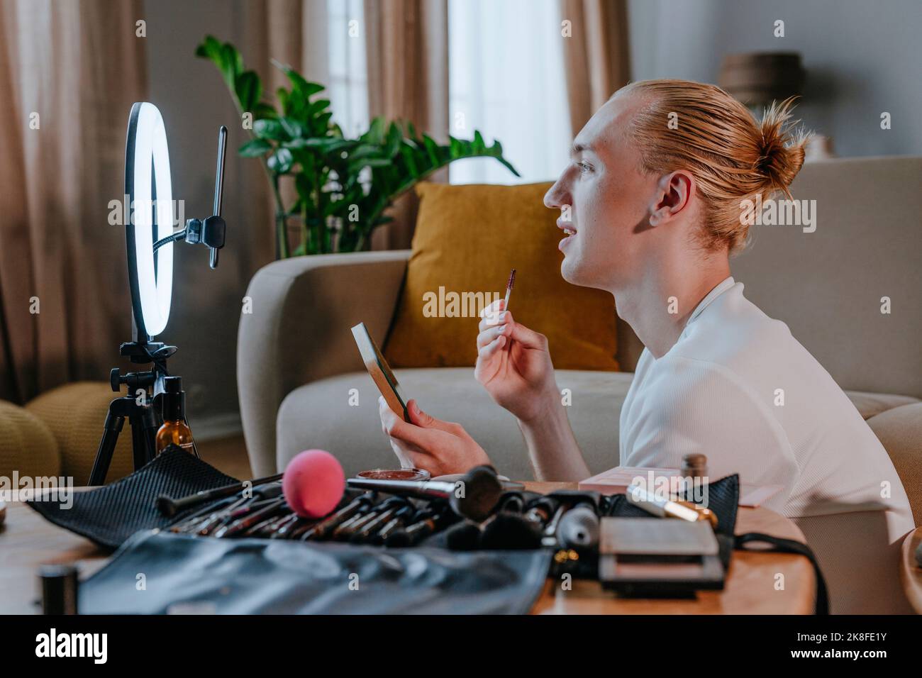 Make-up artist through smart phone vlogging in front of ring light ...