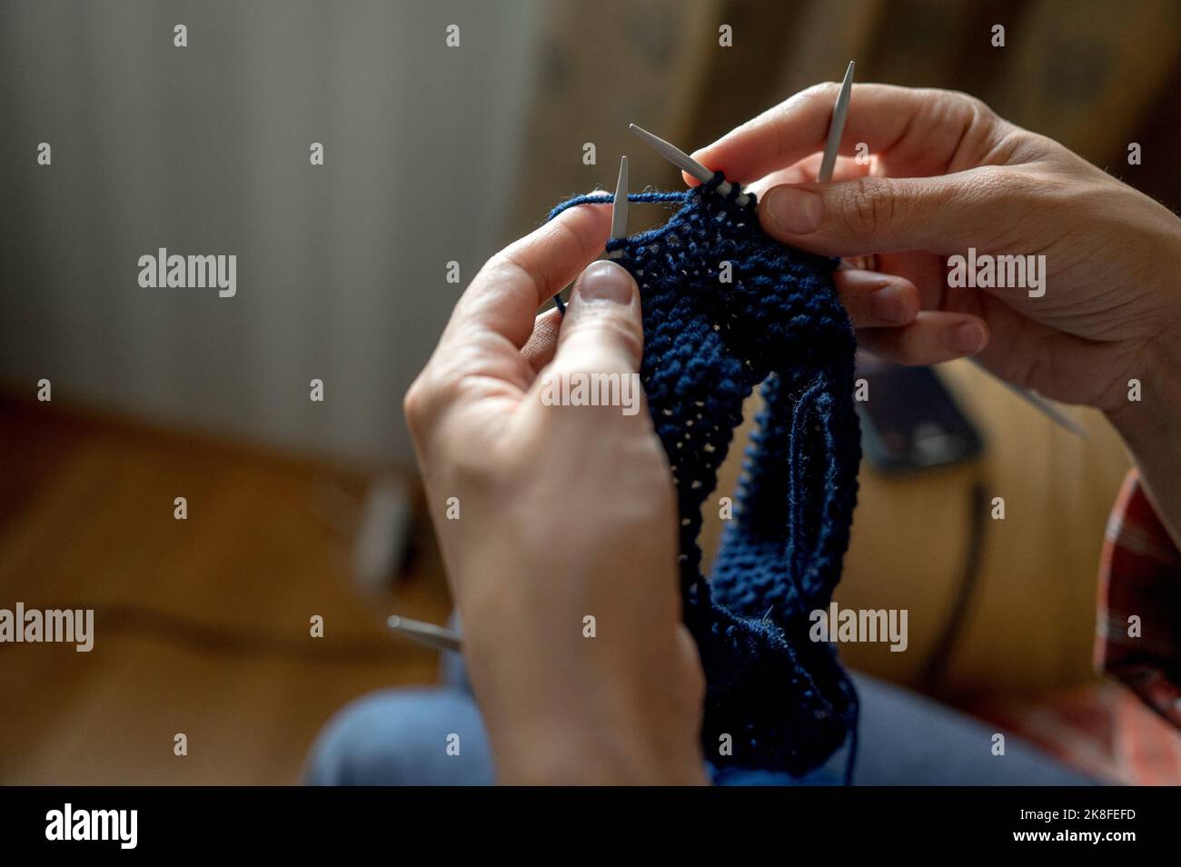 Woman with wool and needles knitting at home Stock Photo - Alamy