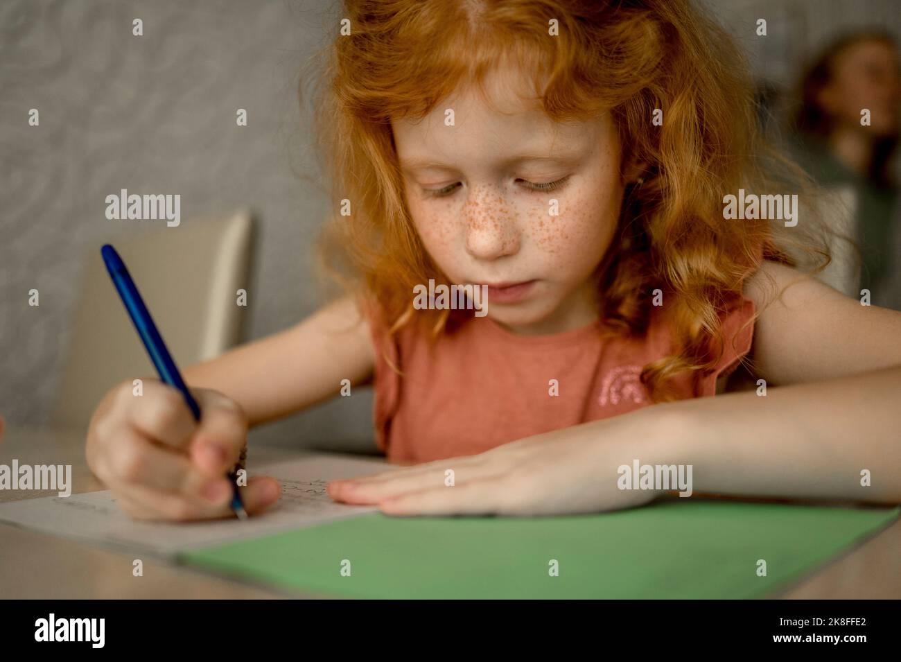 Redhead girl drawing with color pencil at home Stock Photo - Alamy