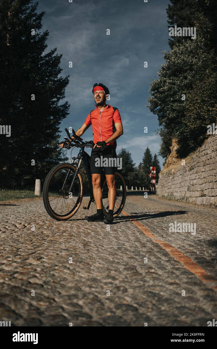 Cyclist standing with bicycle at Gotthard Pass Stock Photo - Alamy