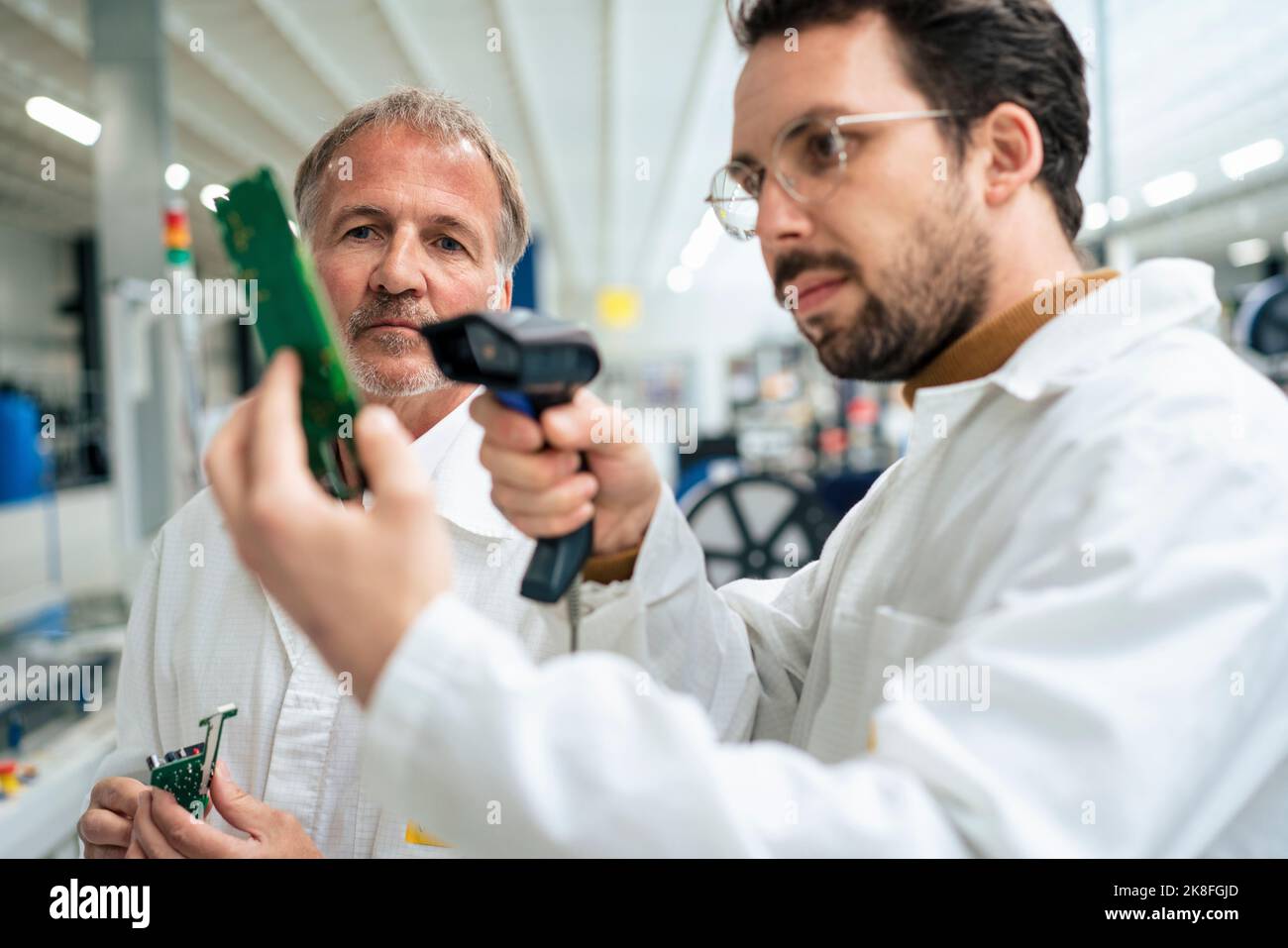 Engineer scanning circuit board with bar code scanner in industry Stock ...