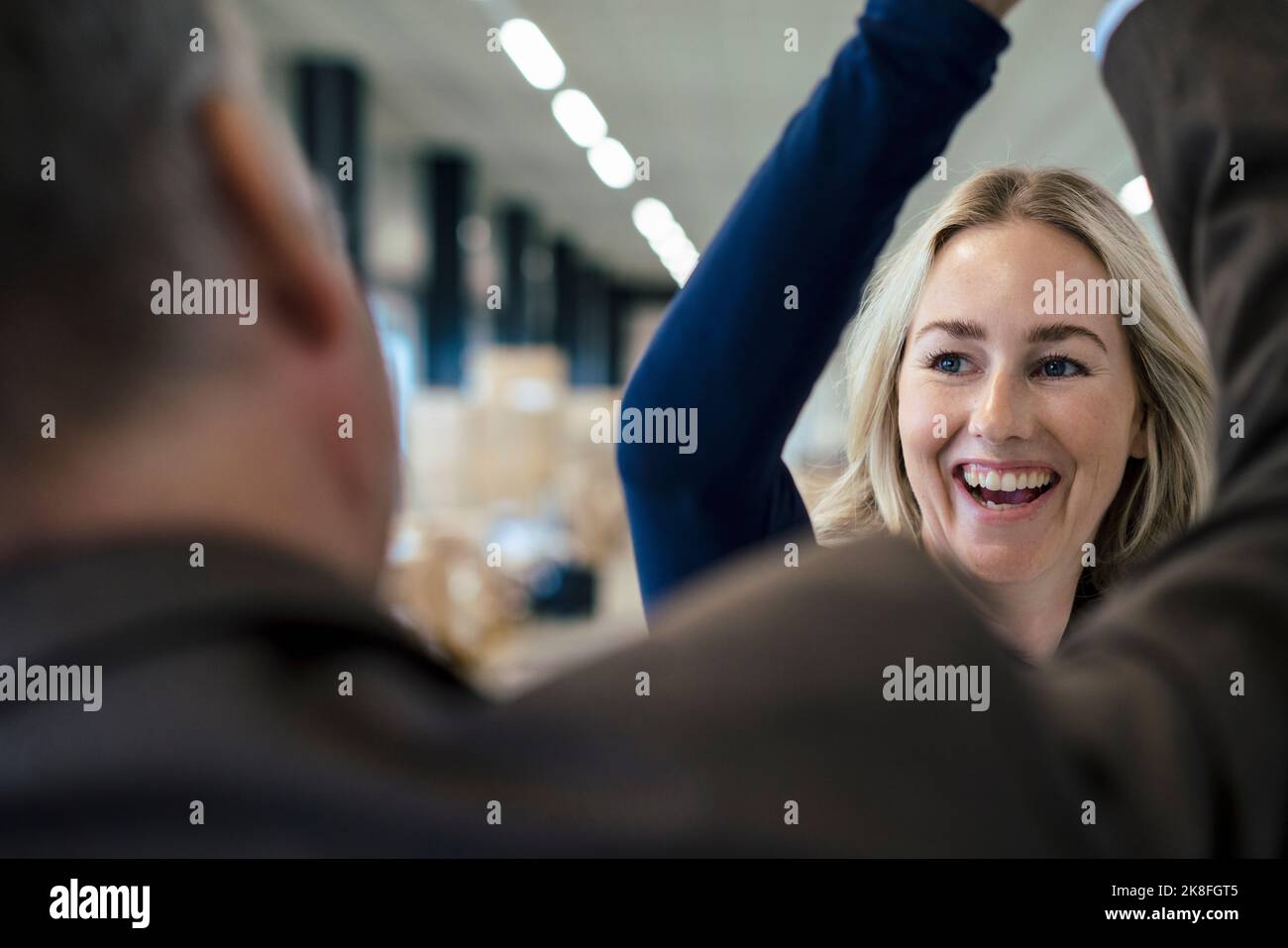 Cheerful businesswoman giving high-five to colleague Stock Photo - Alamy