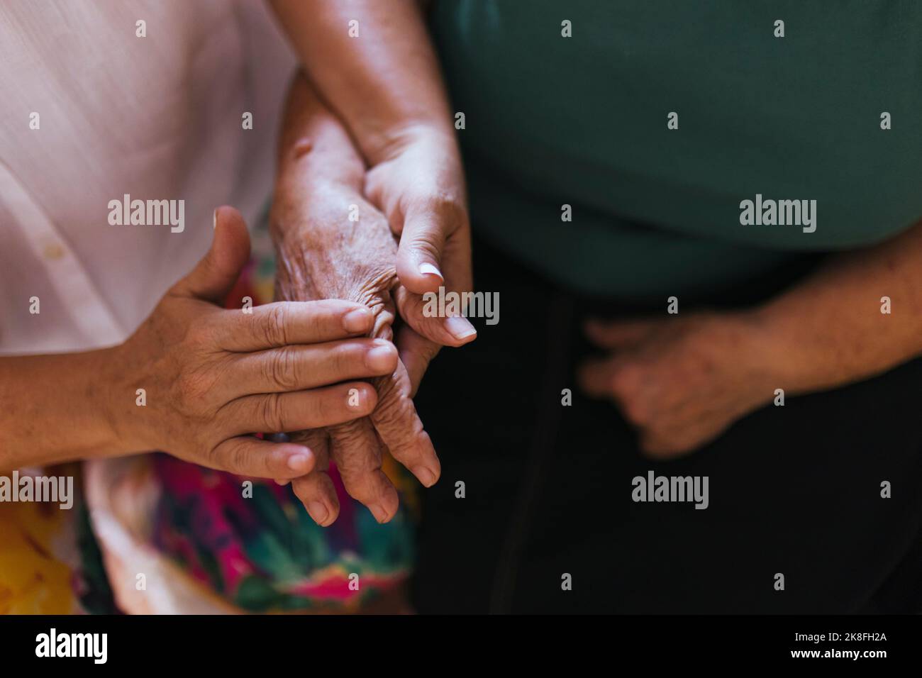 Woman caressing hand of elderly mother Stock Photo - Alamy