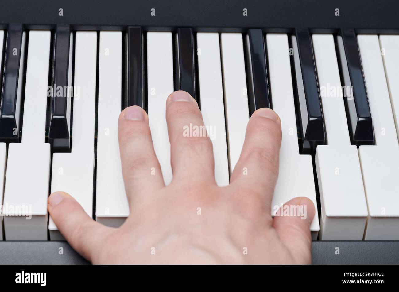 Hand play on piano close up view. Playing on piano theme Stock Photo ...