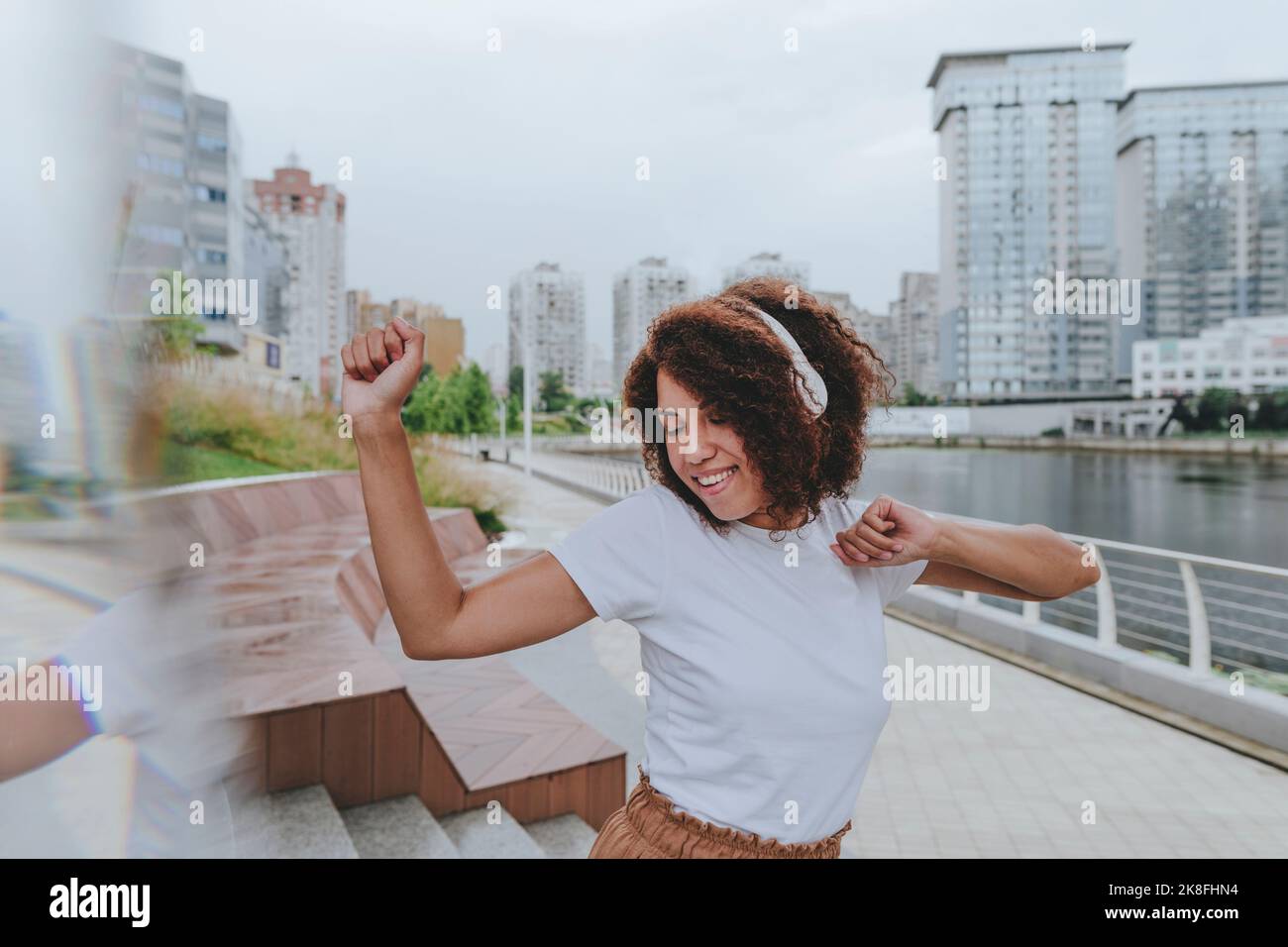 Young woman having fun dancing at promenade Stock Photo - Alamy