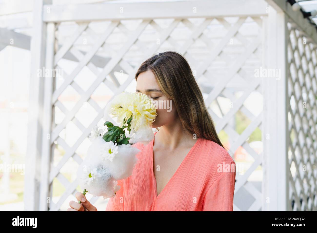 Woman smelling pink flower hi-res stock photography and images - Alamy