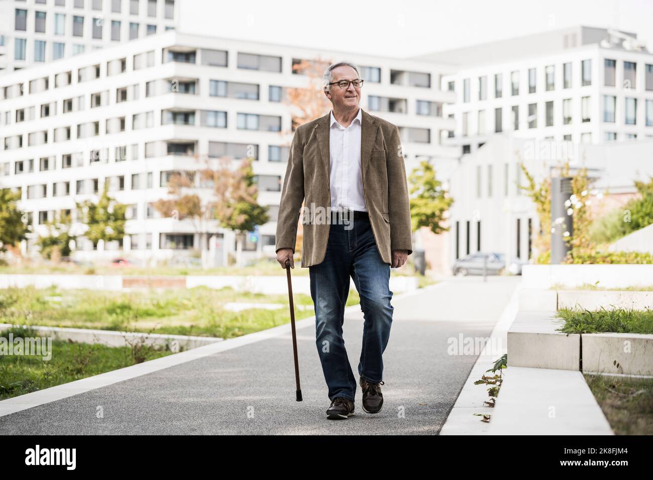 Man walking with cane hi-res stock photography and images - Alamy