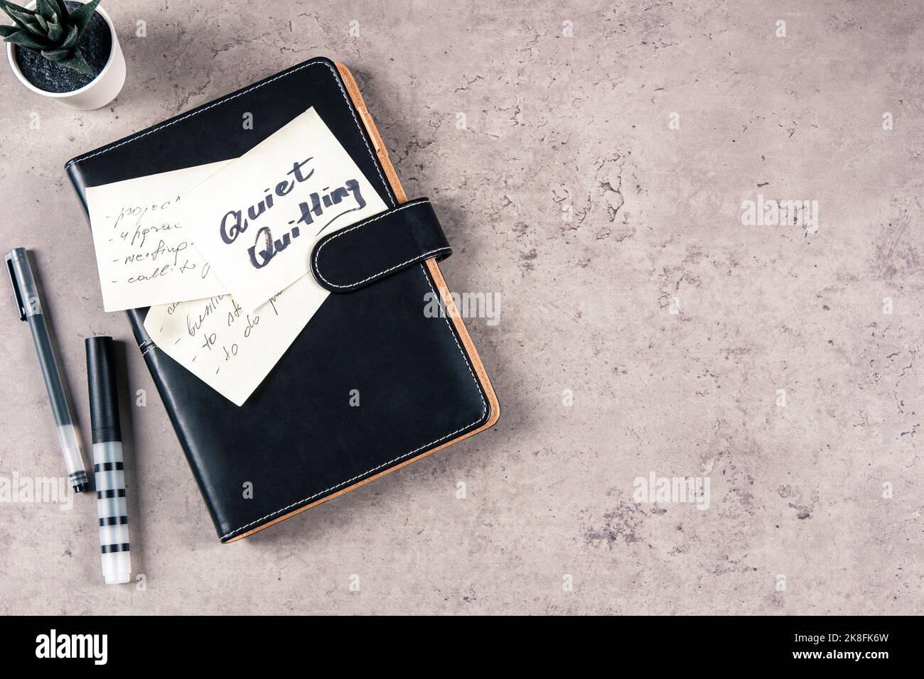 Quiet Quitting. Top view to desk with office supplies. Sticky note with ...