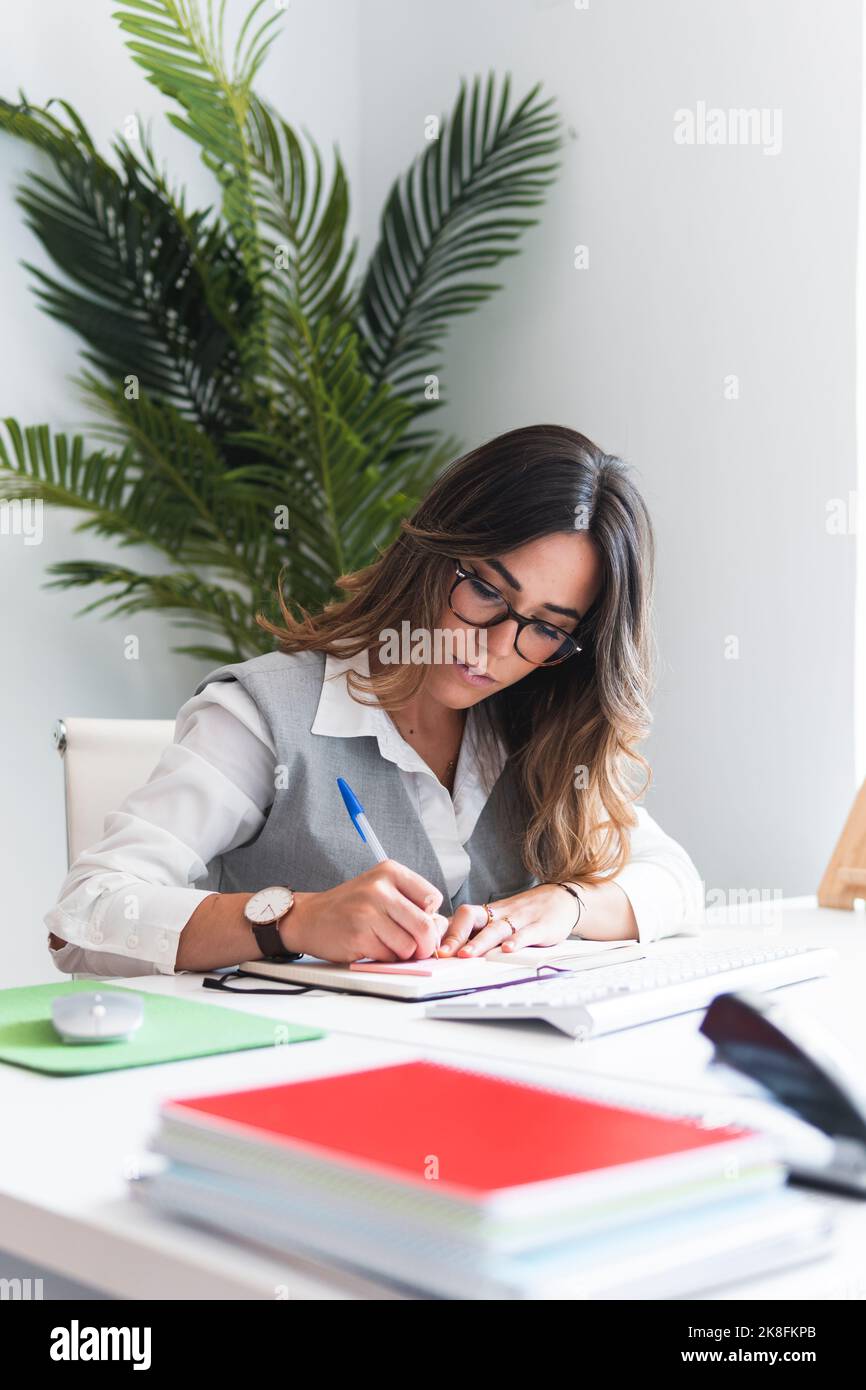 Woman making notes in notepad hi-res stock photography and images - Alamy