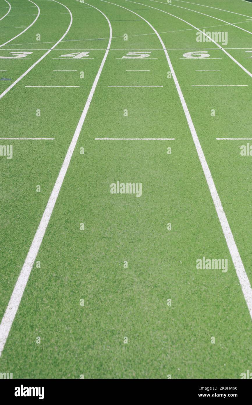 Numbers on empty running track at sports field Stock Photo - Alamy