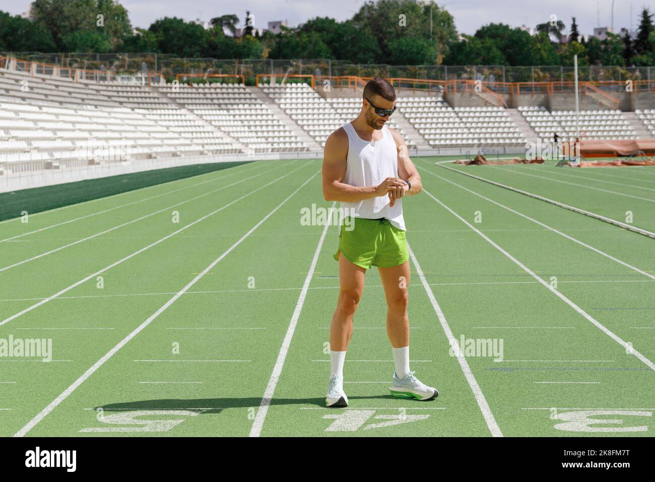 Athlete checking time on smart watch Stock Photo - Alamy