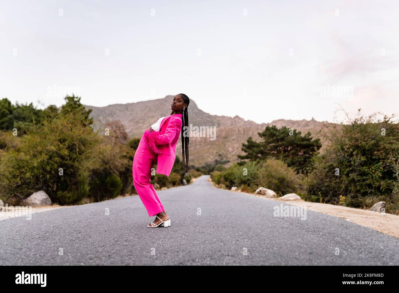 Young woman bending backwards standing on road Stock Photo - Alamy