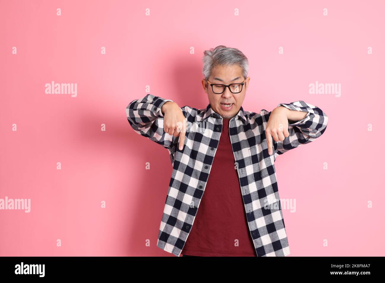 The 40s adult Asian man stnading on the pink background with casual ...