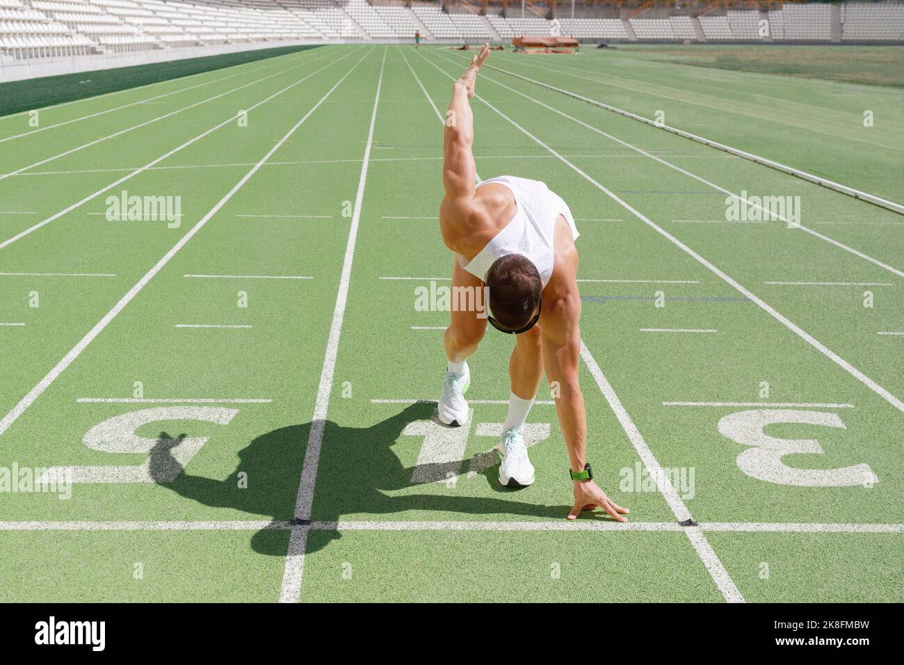 Man on starting line getting ready to race Stock Photo - Alamy
