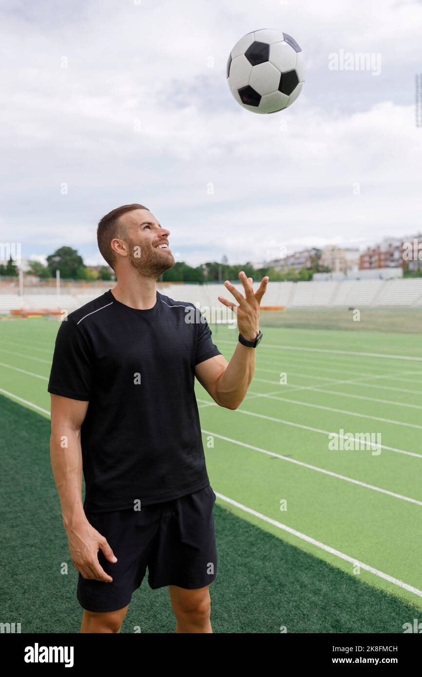 Happy sportsman playing with soccer ball Stock Photo - Alamy
