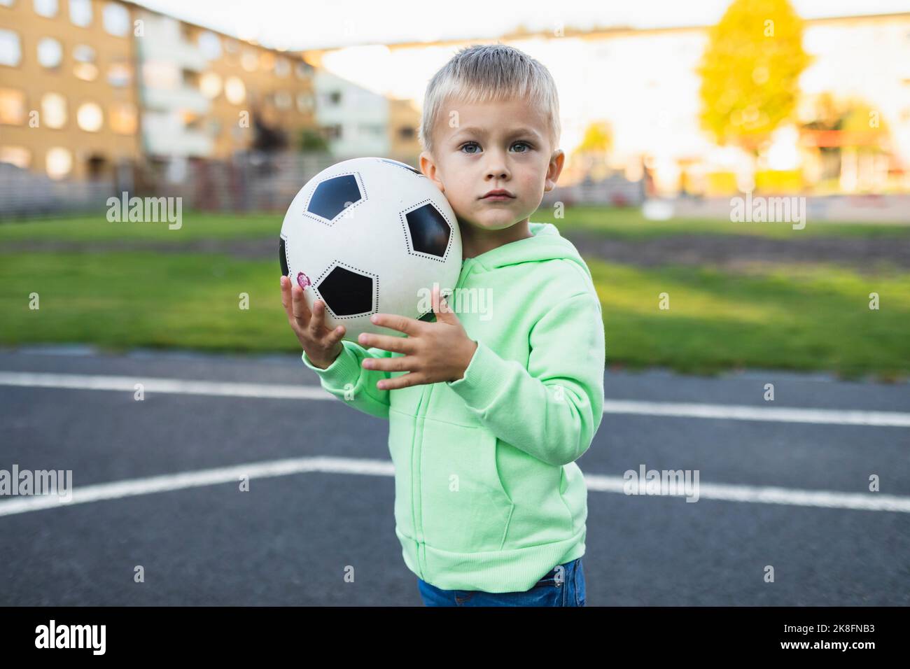 Cute boy with soccer ball in sports court Stock Photo - Alamy