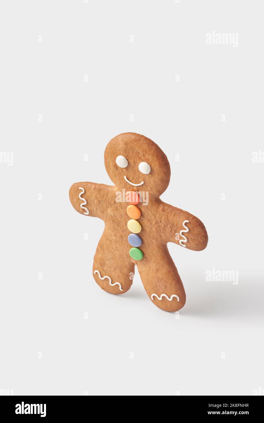 Decorated gingerbread man standing against white background Stock Photo ...