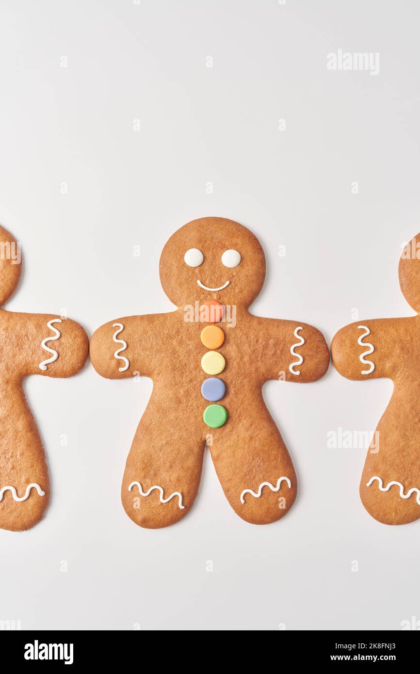 Freshly decorated gingerbread men lying on white background Stock Photo ...
