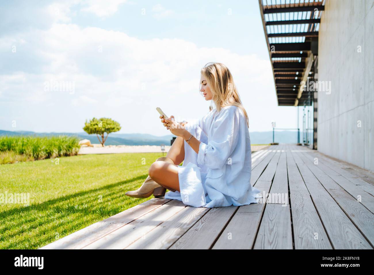 Mature woman sitting on veranda hi-res stock photography and images - Alamy