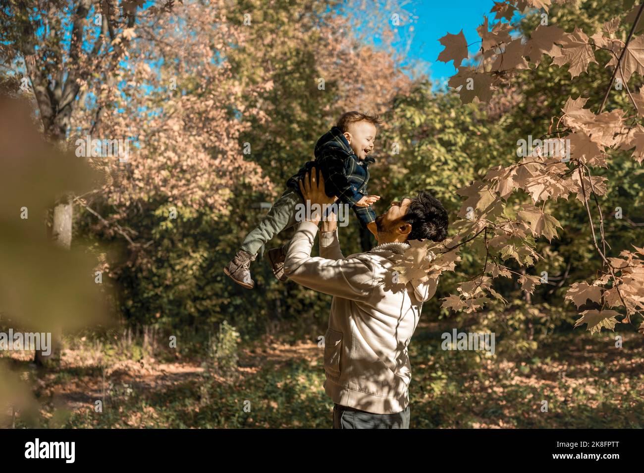 Parents lifting up child park hi-res stock photography and images - Alamy