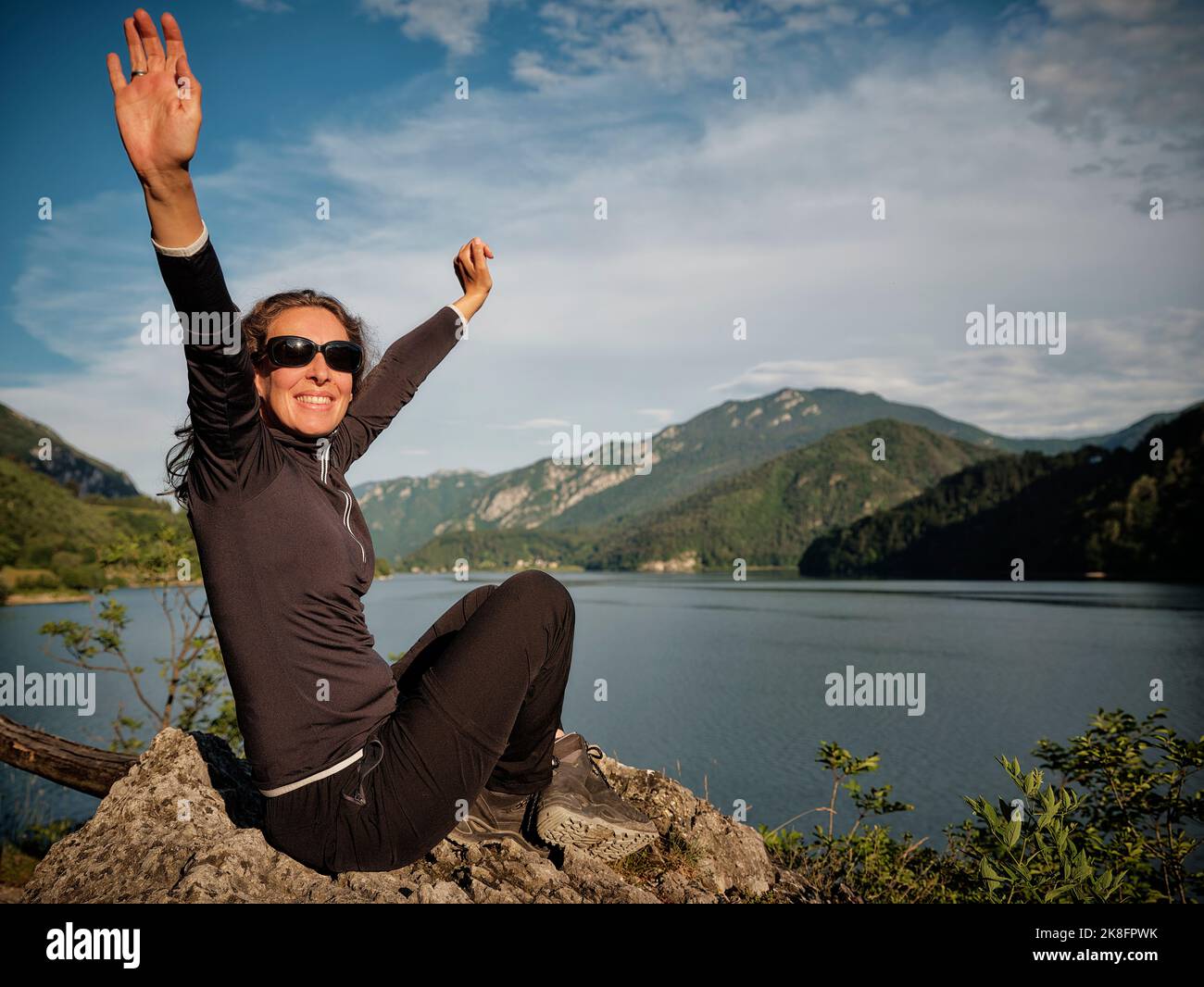 Woman sitting on rock arms hi-res stock photography and images - Alamy