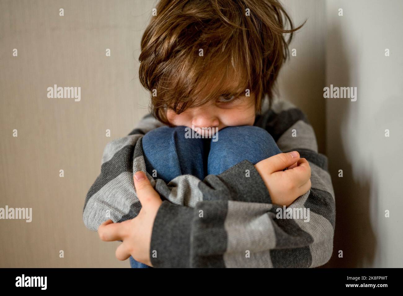 Depressed boy sitting in corner at home Stock Photo - Alamy
