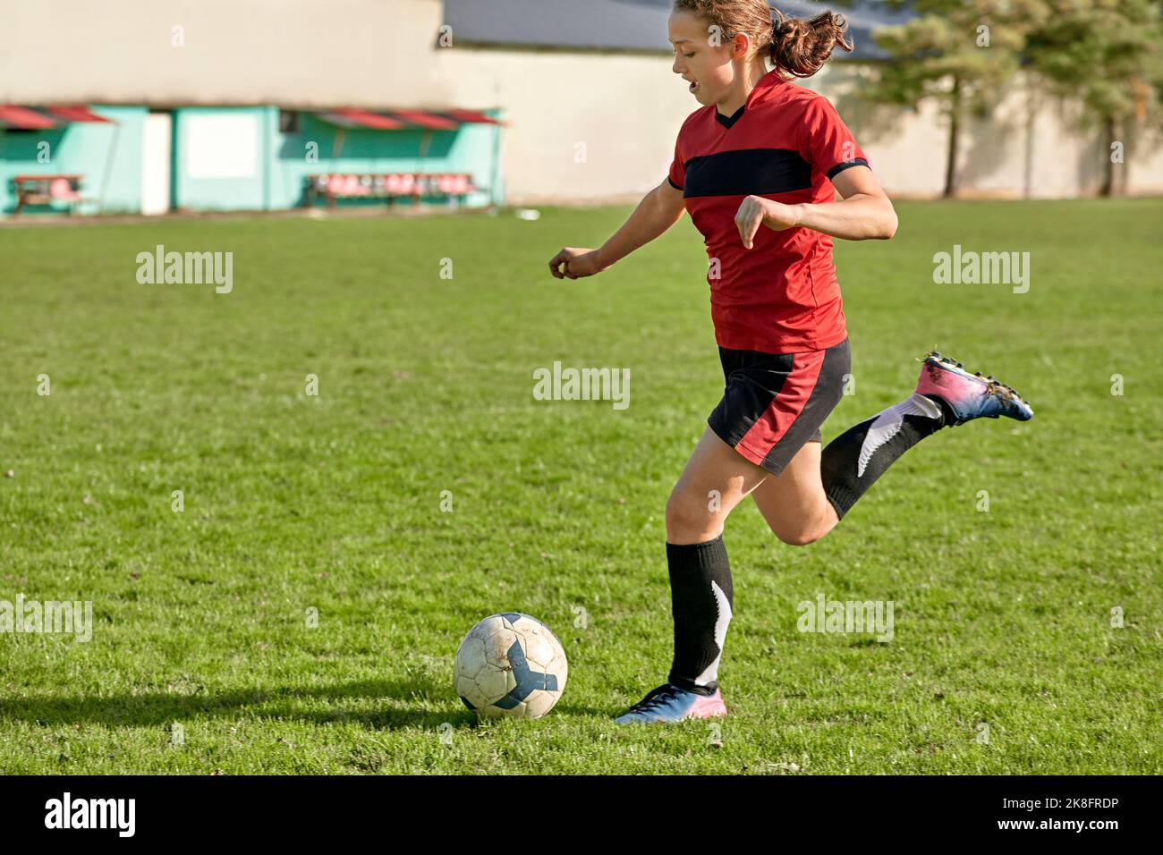 Female soccer player kicking ball hi-res stock photography and images ...