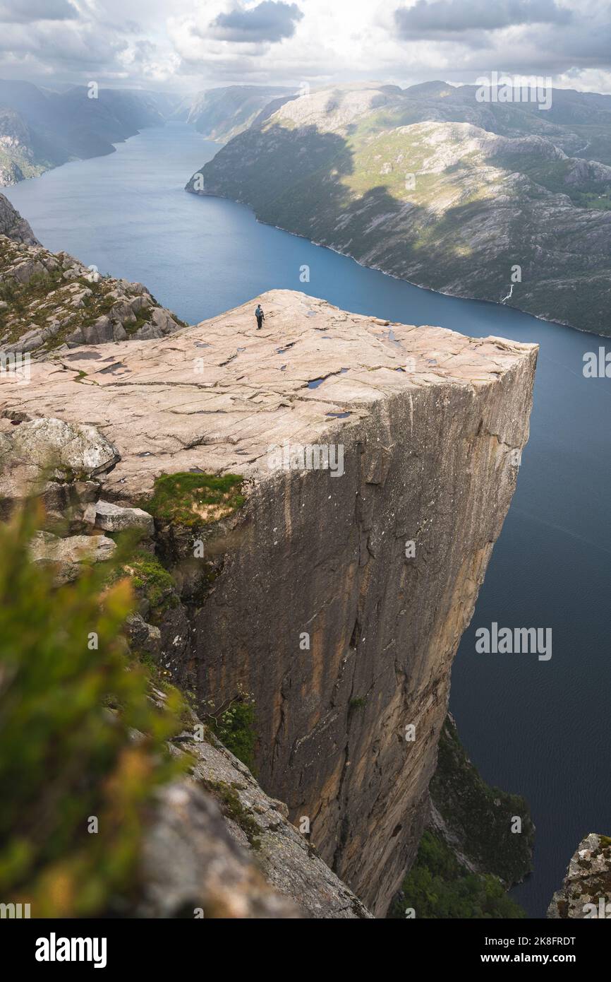 Hiker on majestic Pulpit rock by fjord in Lysefjorden, Norway Stock ... Hiker on majestic Pulpit rock by fjord in Lysefjorden, Norway Stock ...