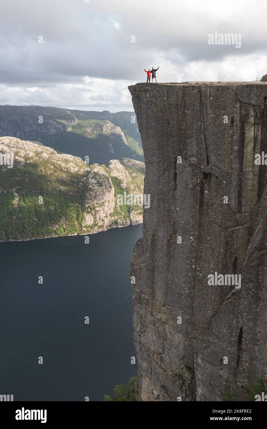 Hiker standing edge majestic pulpit rock cliff lysefjorden fjord hi-res ...
