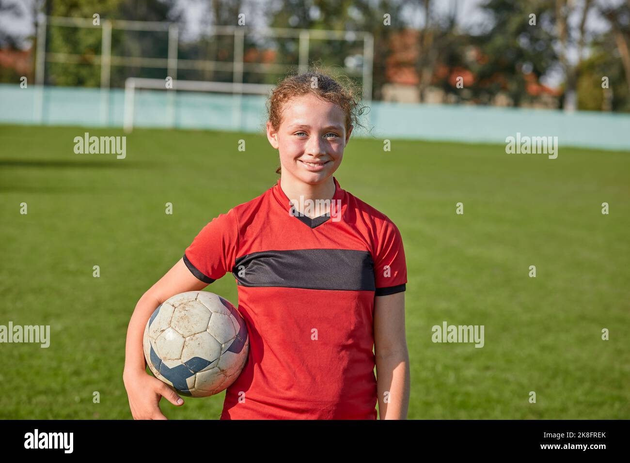 Girl smiling with soccer ball hi-res stock photography and images - Alamy