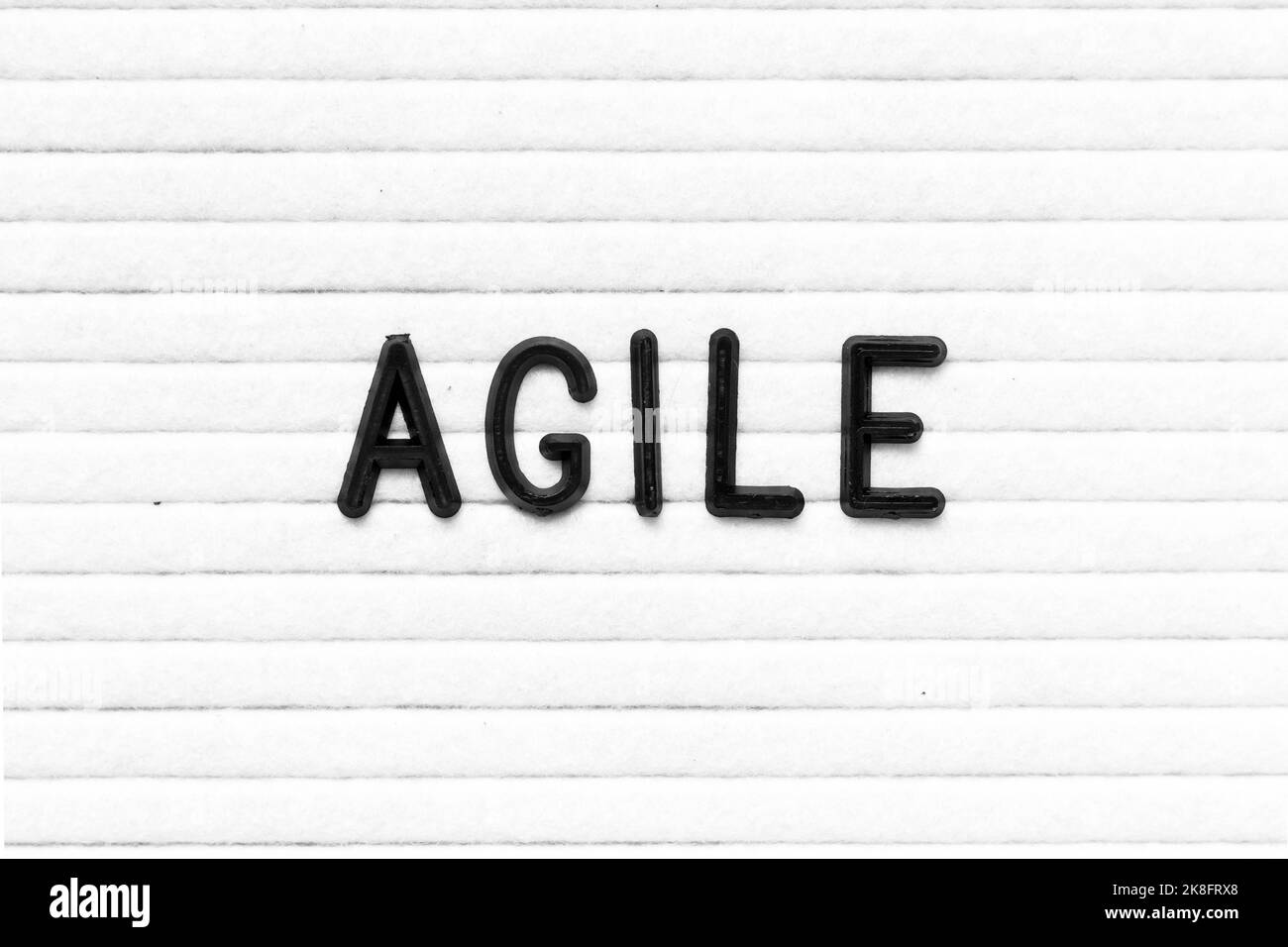 Black color letter in word agile on white felt board background Stock ...