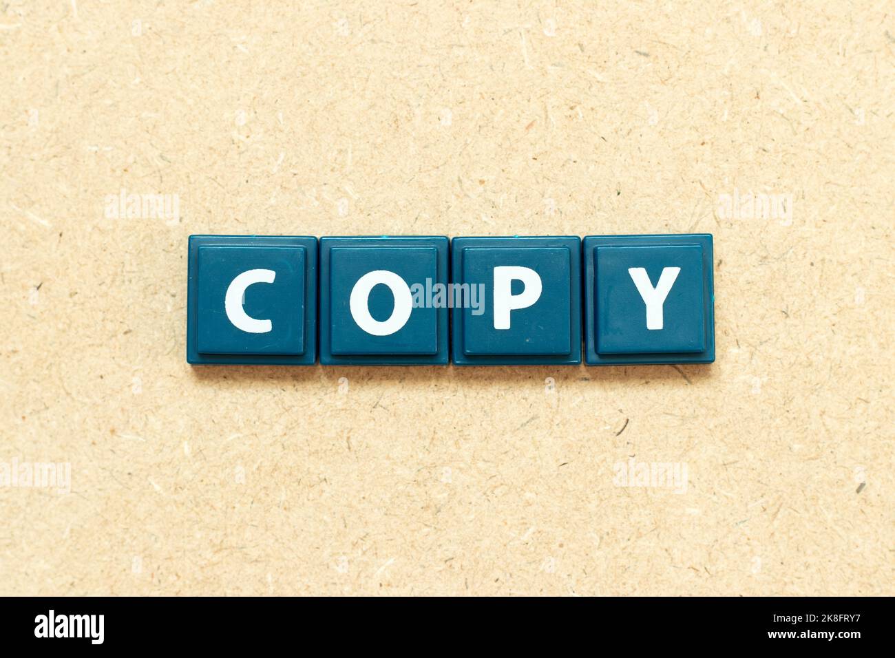 Tile alphabet letter in word copy on wood background Stock Photo - Alamy