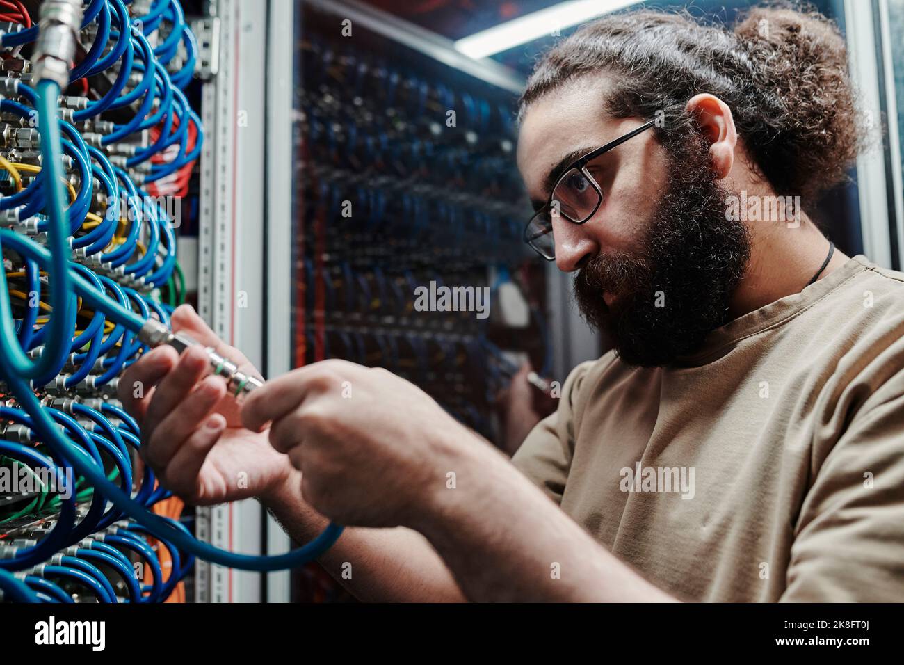 Concentrated IT expert connecting cables in data center Stock Photo - Alamy
