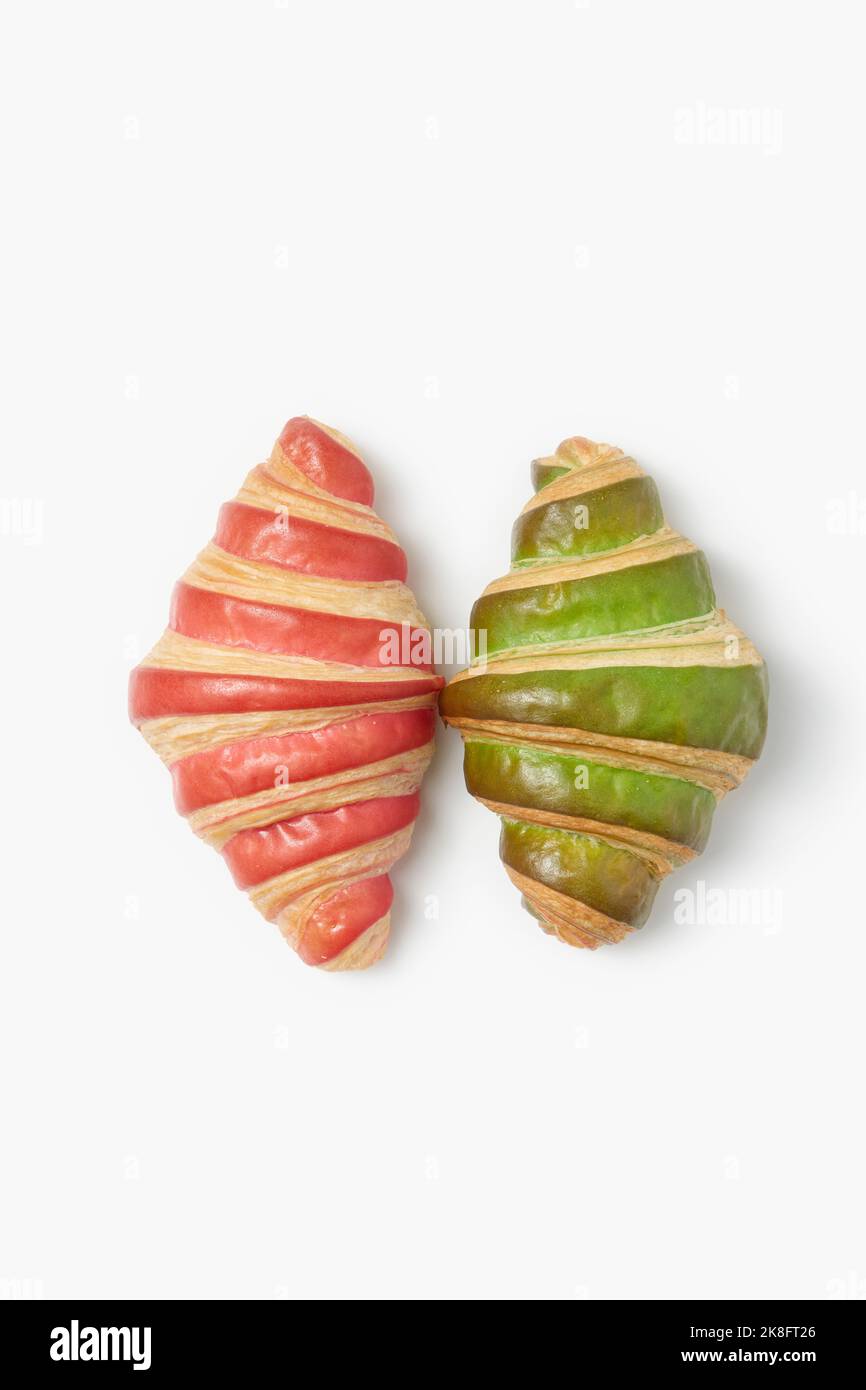 Pink and green striped croissants on white background Stock Photo - Alamy
