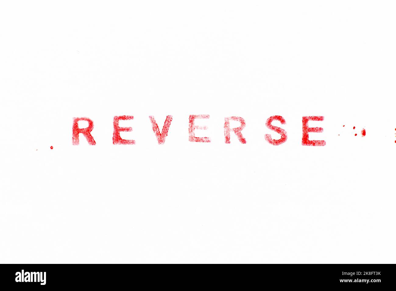 Red color ink rubber stamp in word reverse on white paper background ...