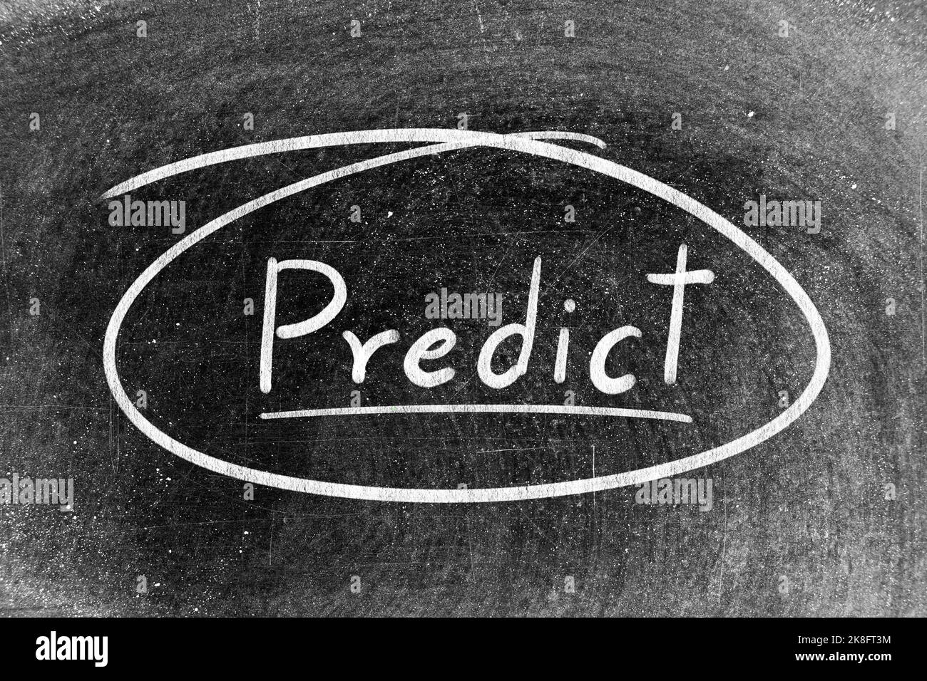 White chalk hand writing in word predict and circle shape on blackboard ...