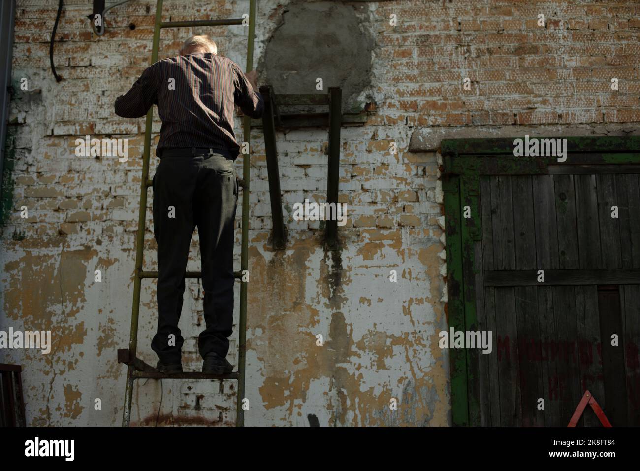 Man on stairs. Man climbs on roof. Worker goes downstairs. Inspection ...