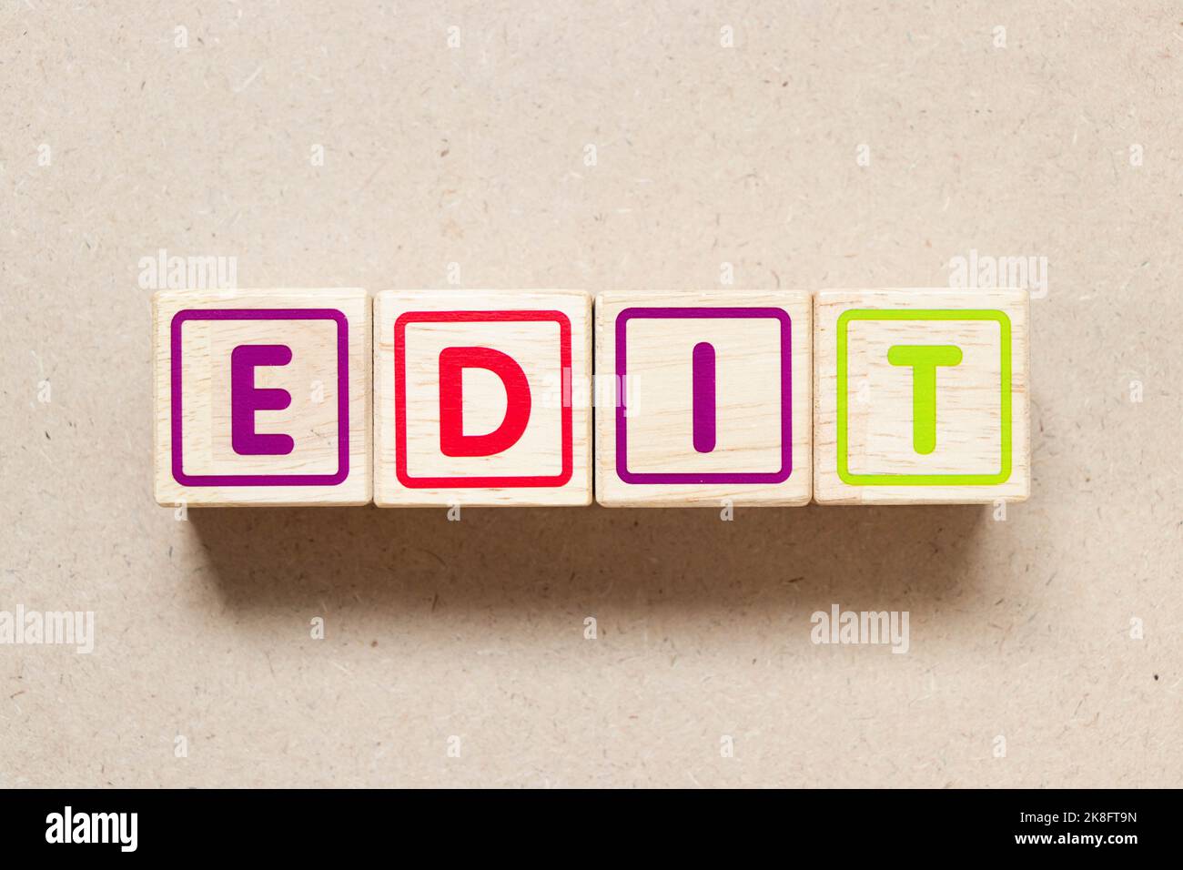 Color letter block in word edit on wood background Stock Photo - Alamy