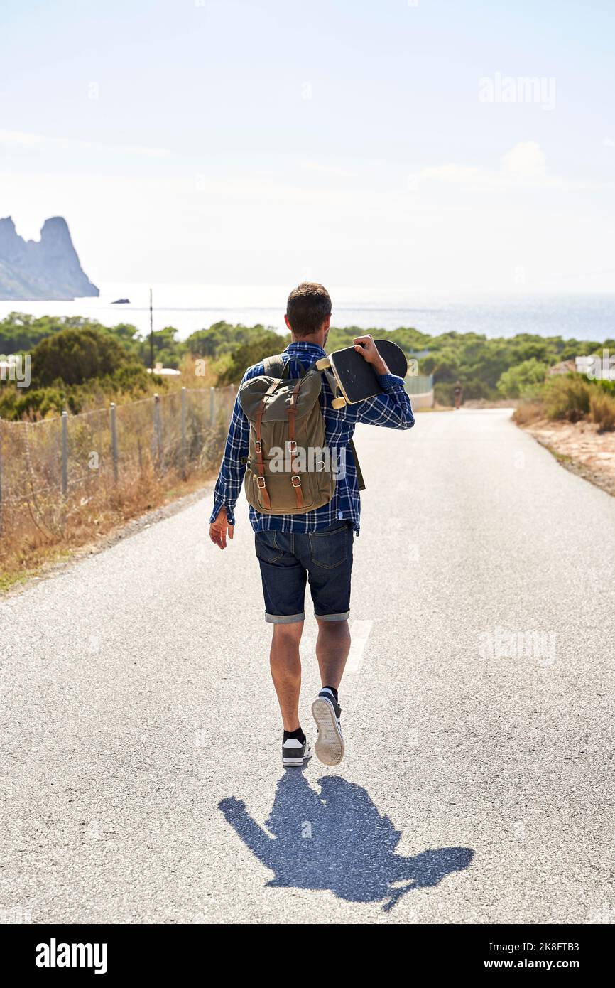 Man walking wearing backpack hi-res stock photography and images - Alamy