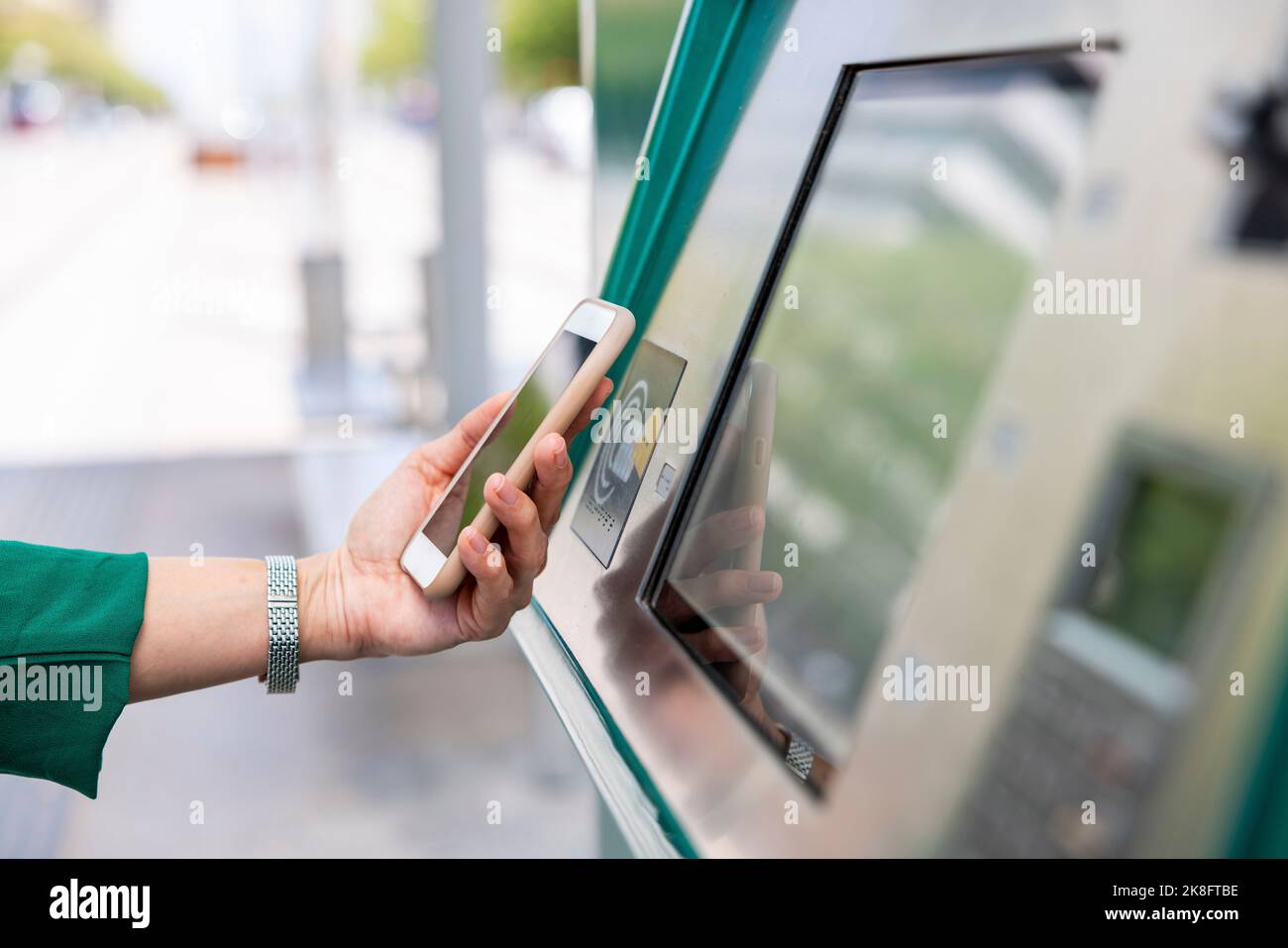 Hand of woman scanning on ticket machine with smart phone Stock Photo ...