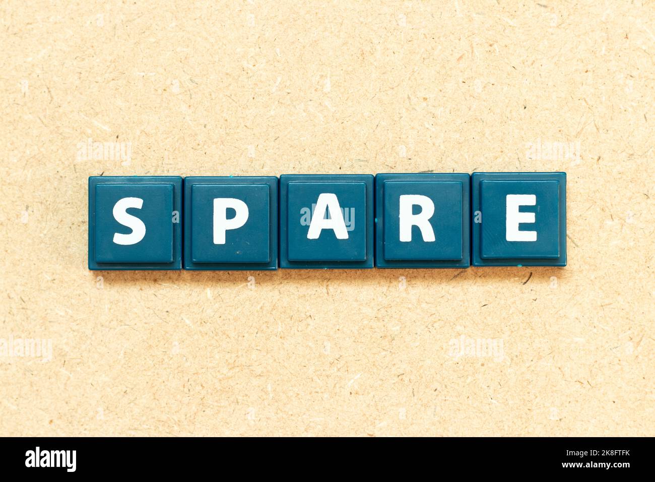 Tile alphabet letter in word spare on wood background Stock Photo - Alamy