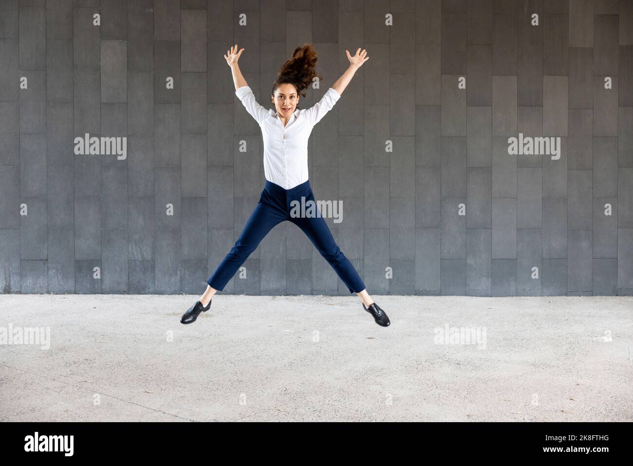 Women jumping raising arms hi-res stock photography and images - Alamy