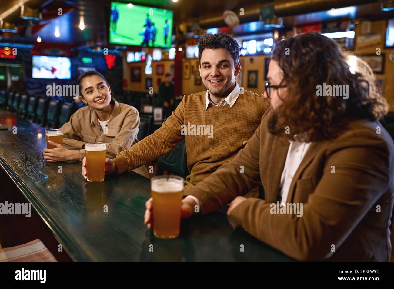 Group of happy friends resting and talking at bar or pub Stock Photo ...