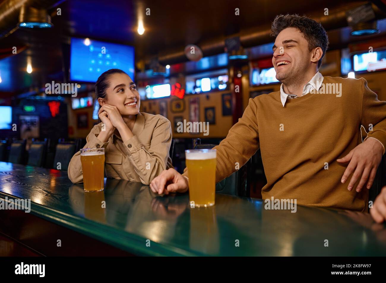 Happy friends drinking beer in pub enjoy nice conversation Stock Photo ...