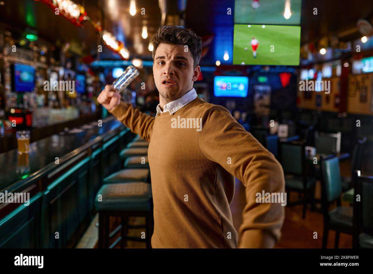 Angry man attacking with empty beer bottle Stock Photo - Alamy