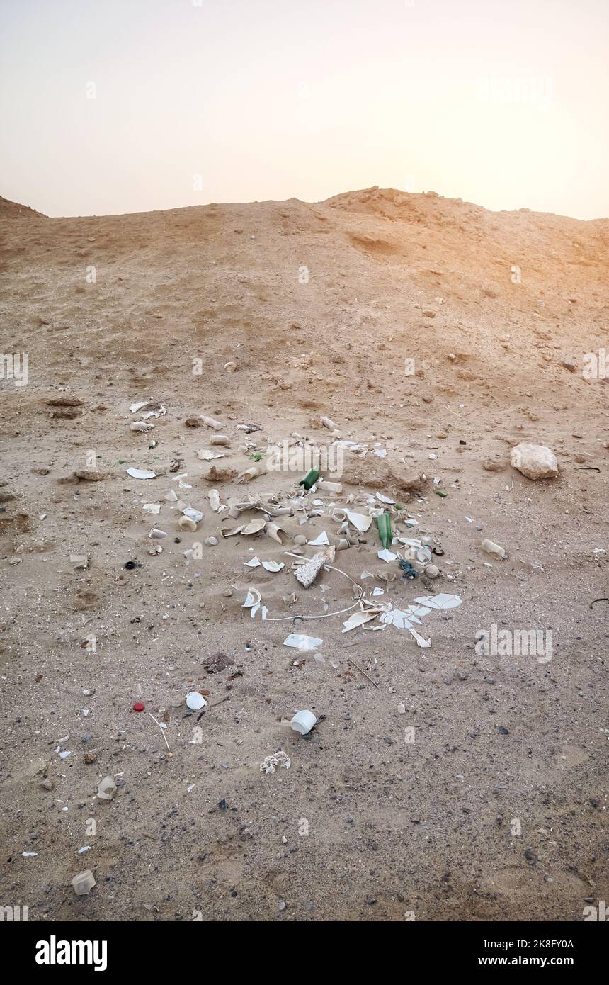 Garbage discarded on a desert sand Stock Photo - Alamy