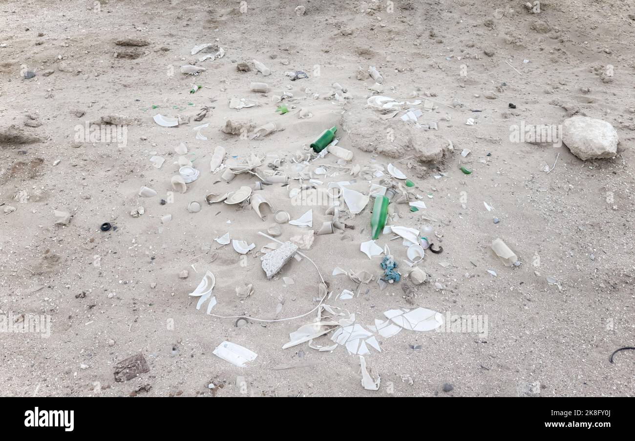 Garbage discarded on a desert sand Stock Photo - Alamy