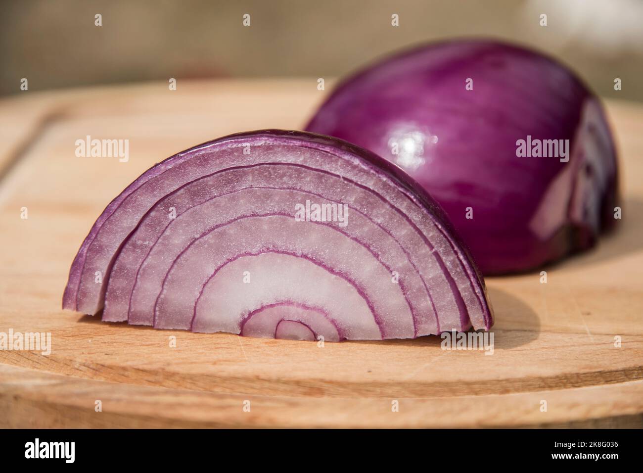 Fresh red onion and cut in half sliced on wooden board background Stock ...