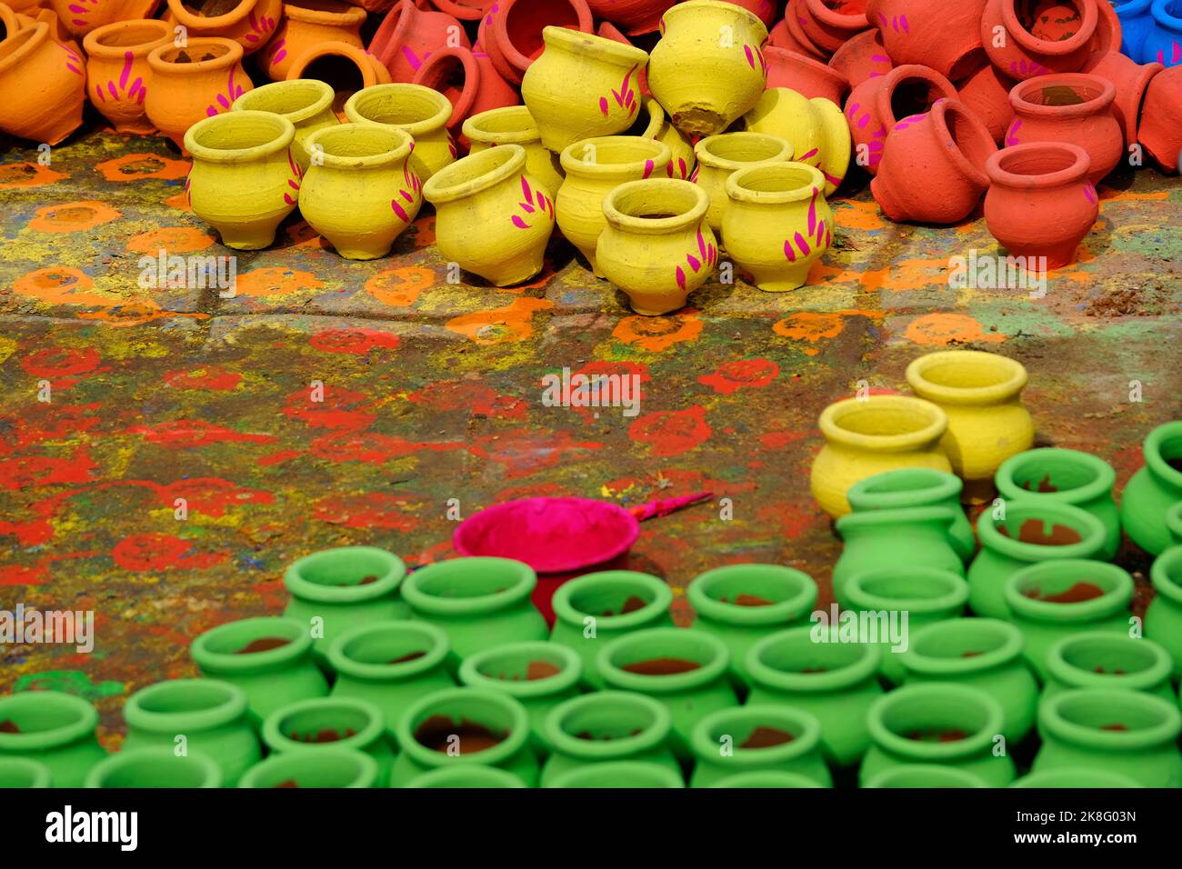 Artisan painting earthen pots, A background of colorful pots used for ...